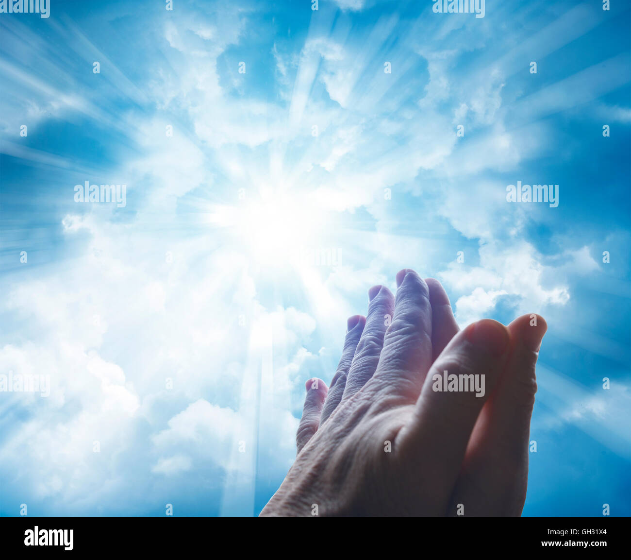 Hands Together Praying In Bright Sky Stock Photo Alamy