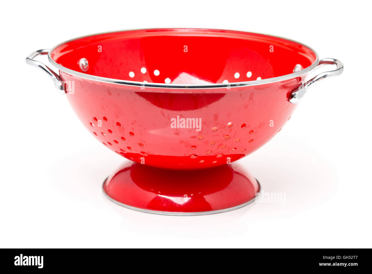 Empty red colander over white background Stock Photo - Alamy