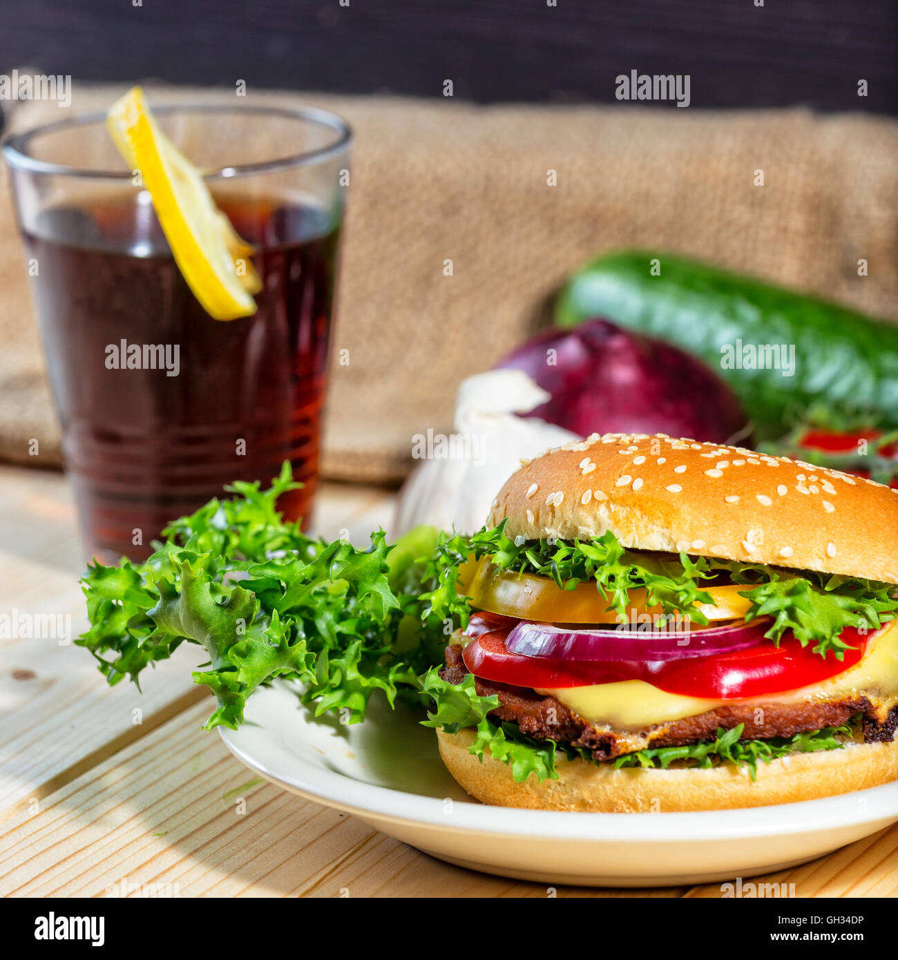 hamburger and drink with slice of lemon Stock Photo - Alamy