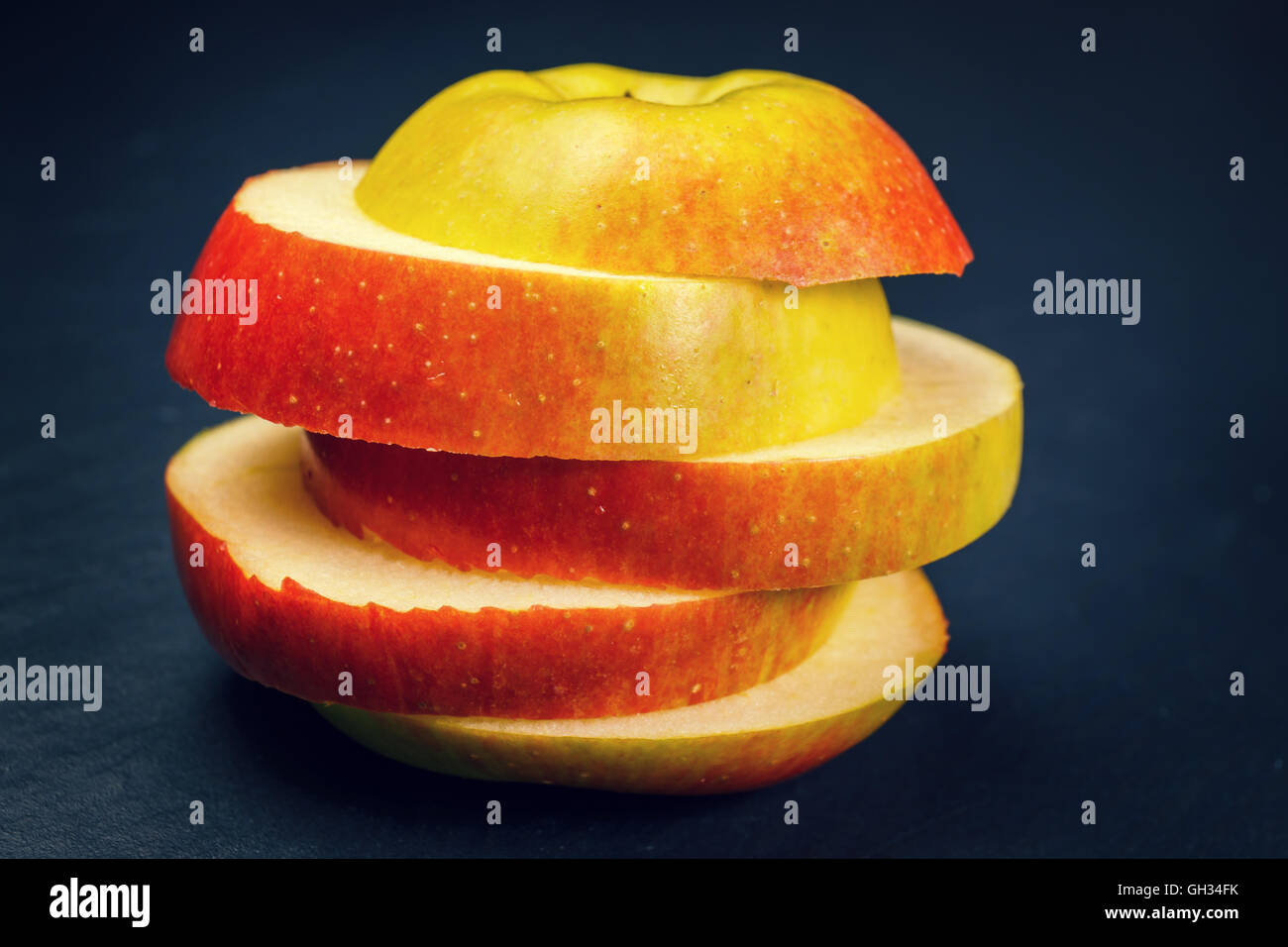 sliced apple on black background Stock Photo - Alamy