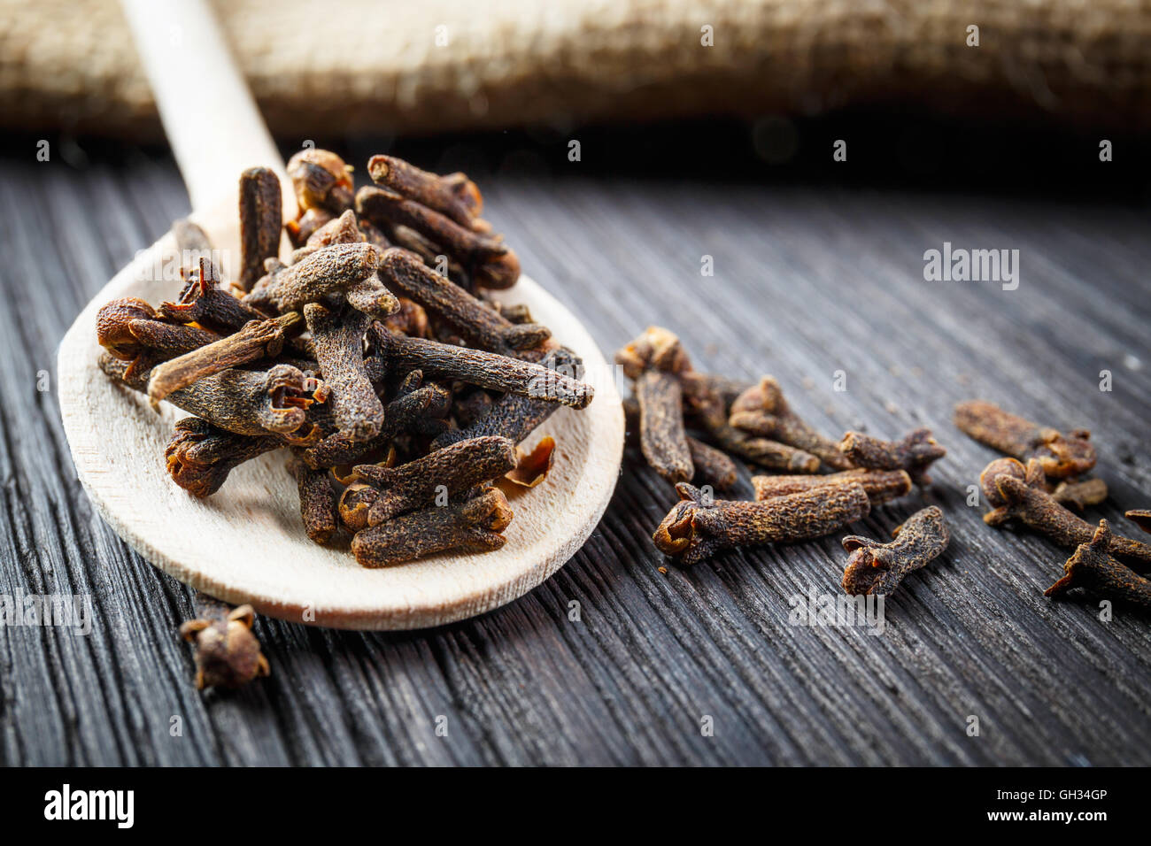pile cloves on wooden spoon Stock Photo - Alamy