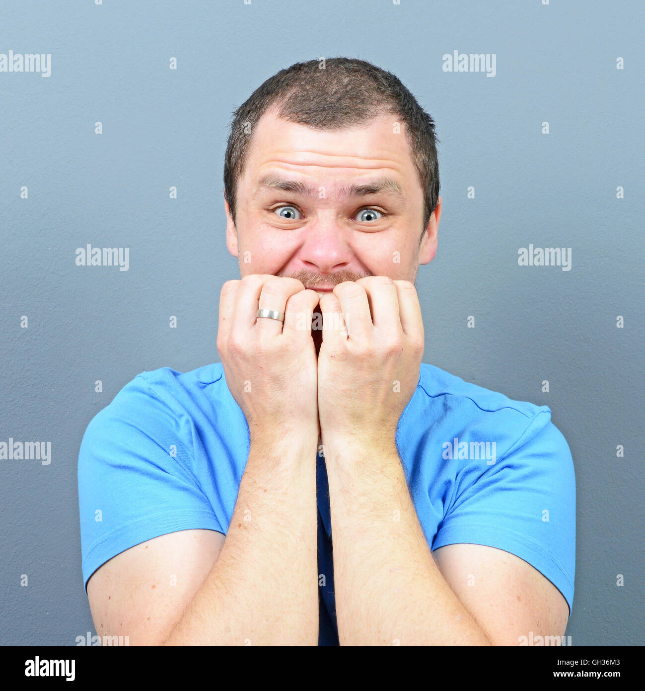 Worried young man biting hi-res stock photography and images - Alamy