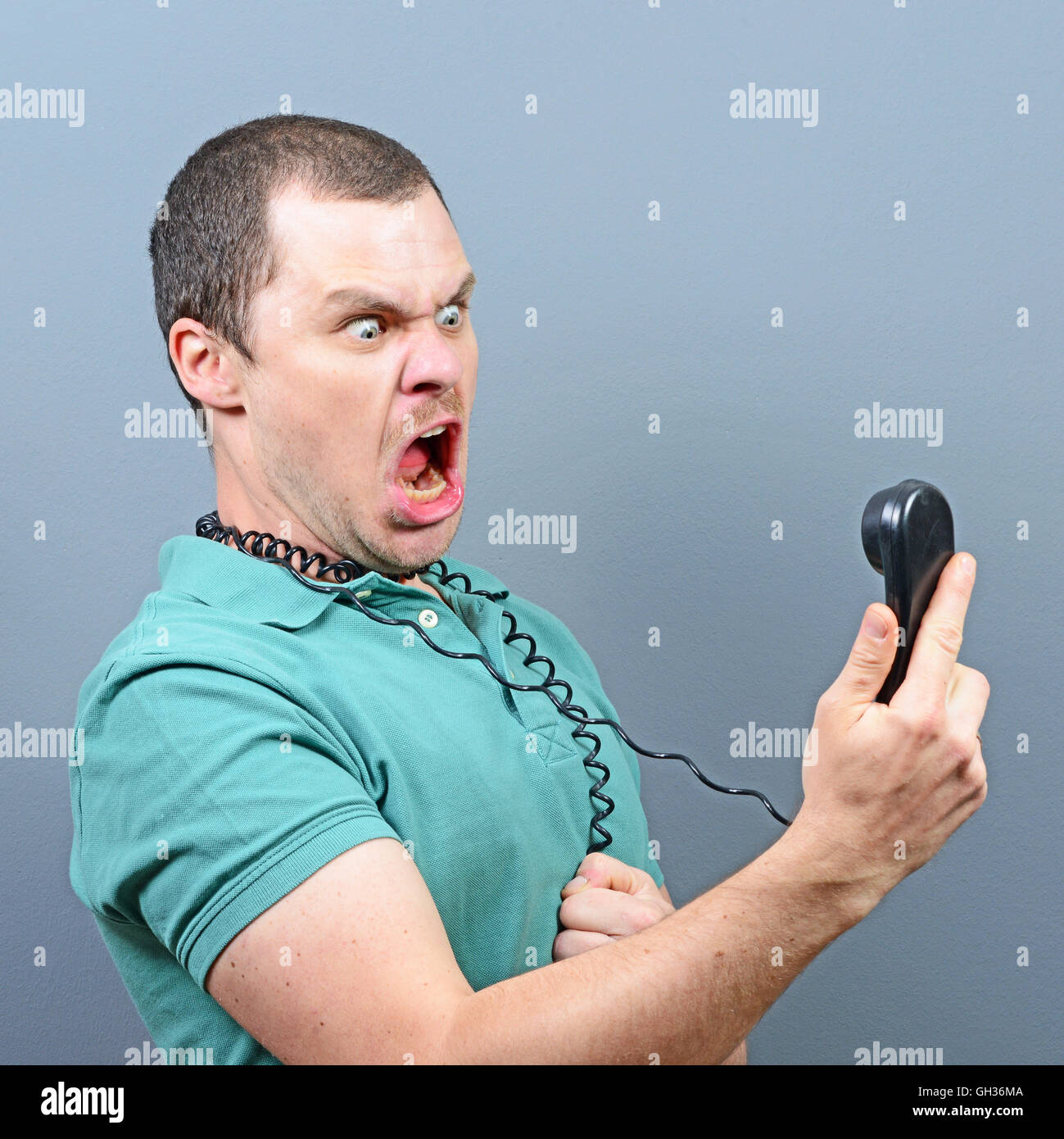 Man having unpleasant conversation on telephone Stock Photo - Alamy
