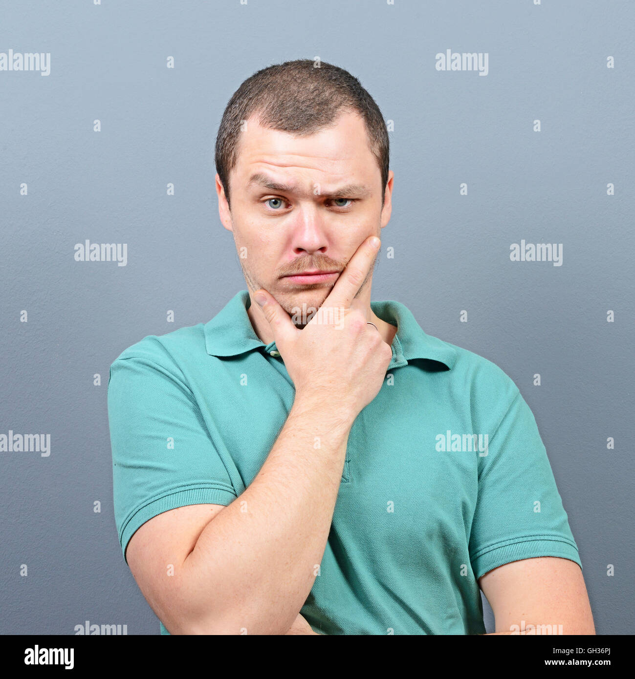 Portrait of a mad looking man against gray background Stock Photo - Alamy