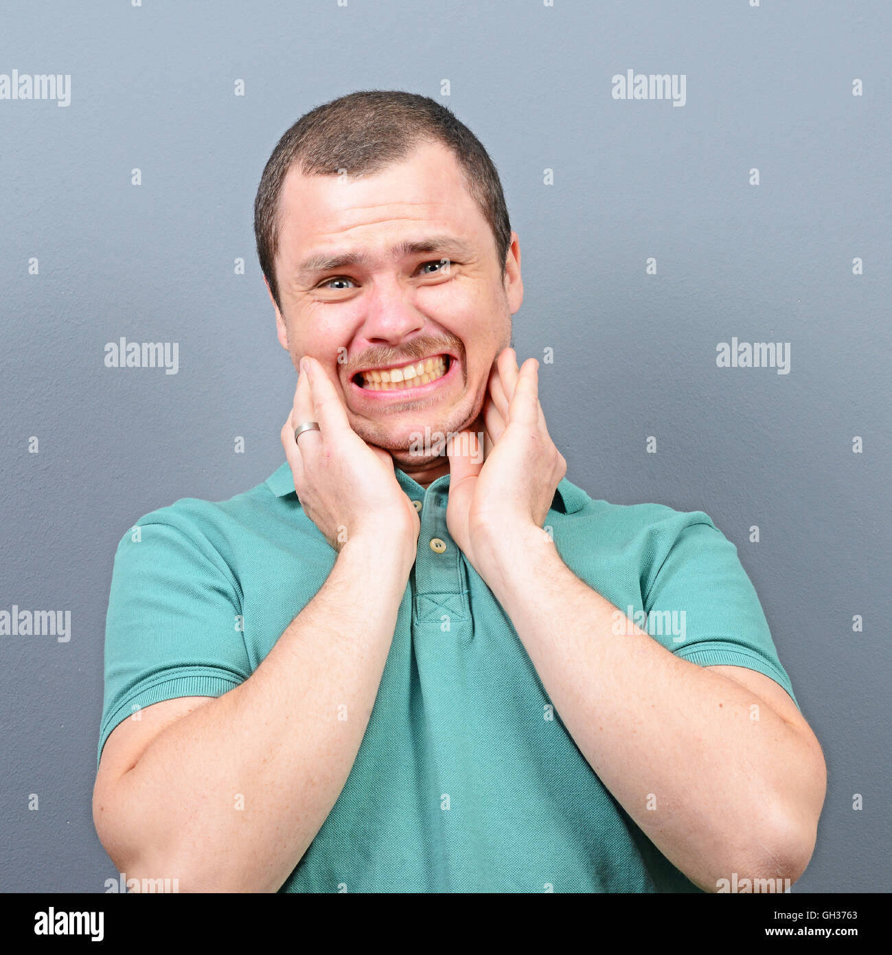 Portrait of shocked man against gray background Stock Photo - Alamy