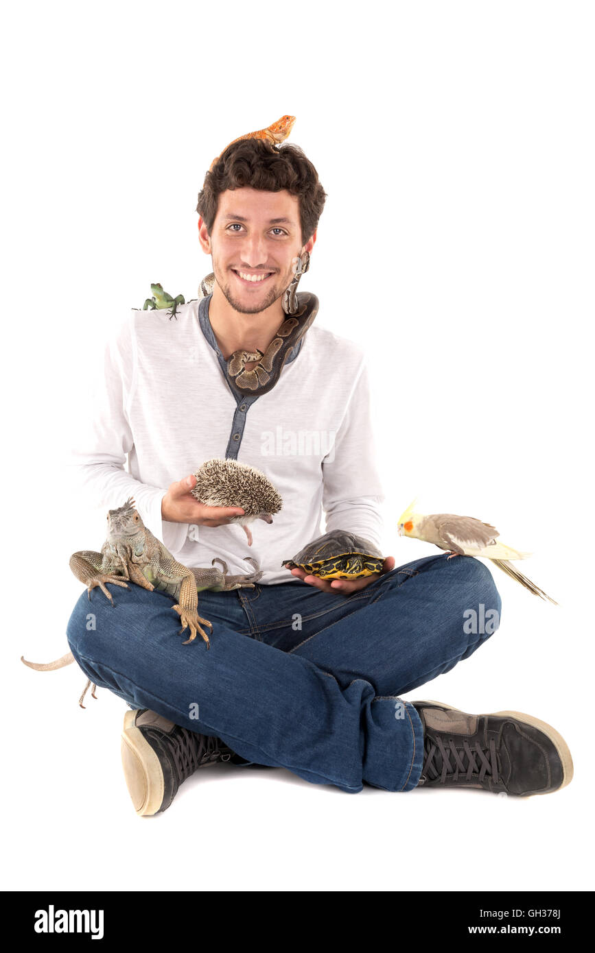 Young man with several pet animals isolated in white Stock Photo - Alamy
