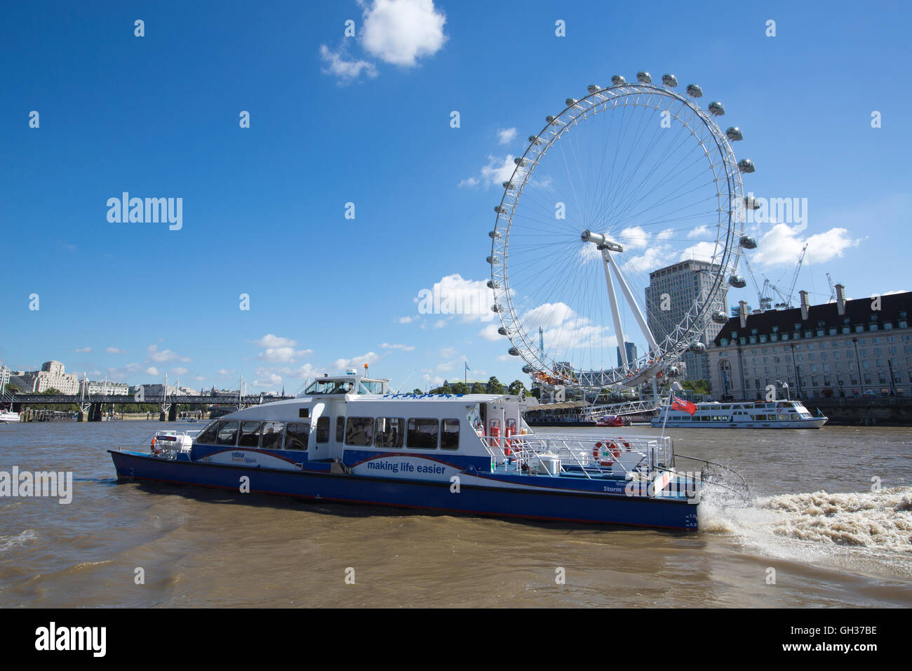 River Thames Clipper passenger ferry boat in front of the London Eye ...