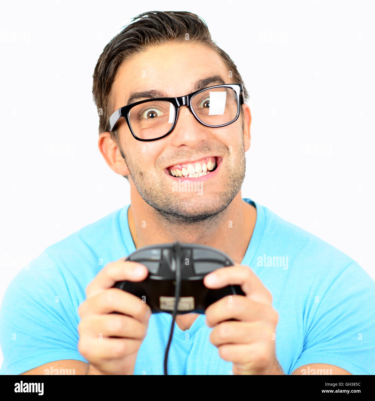 Portrait of handsome man holding joystick for video games against white ...