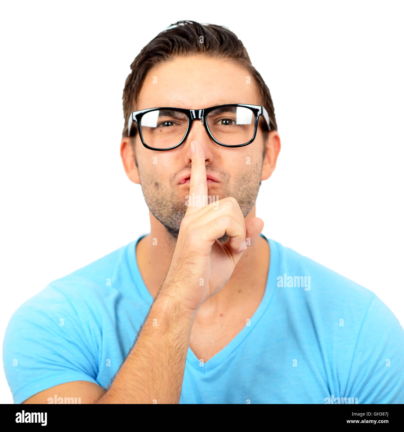 Portrait of man with gesture for silence against white background Stock ...