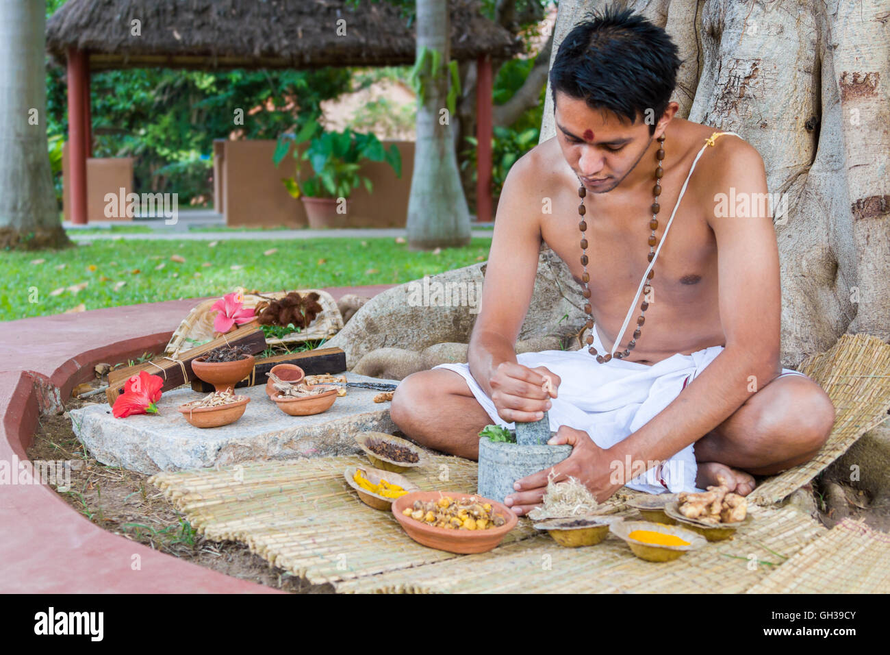 A young Indian doctor preparing traditional ayurvedic, herbal, medicine Stock Photo - Alamy