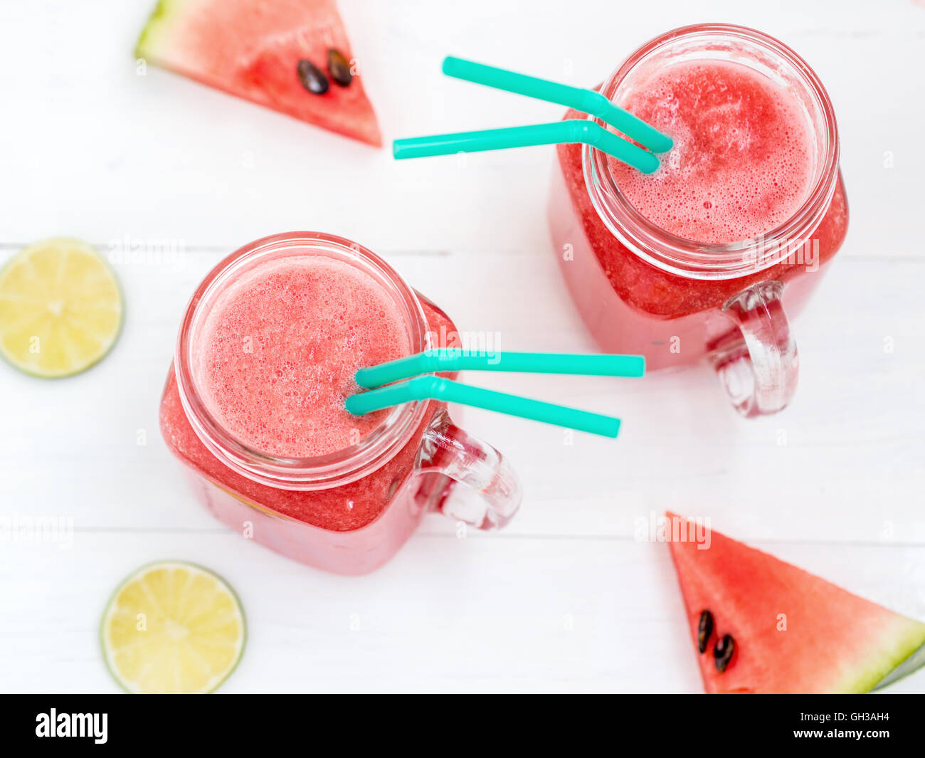 Watermelon smothie and slices on white background Stock Photo - Alamy