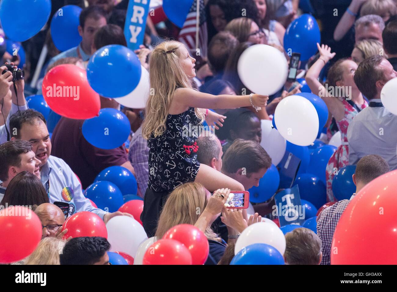 A young girl grabs balloons during the finale of the Democratic ...