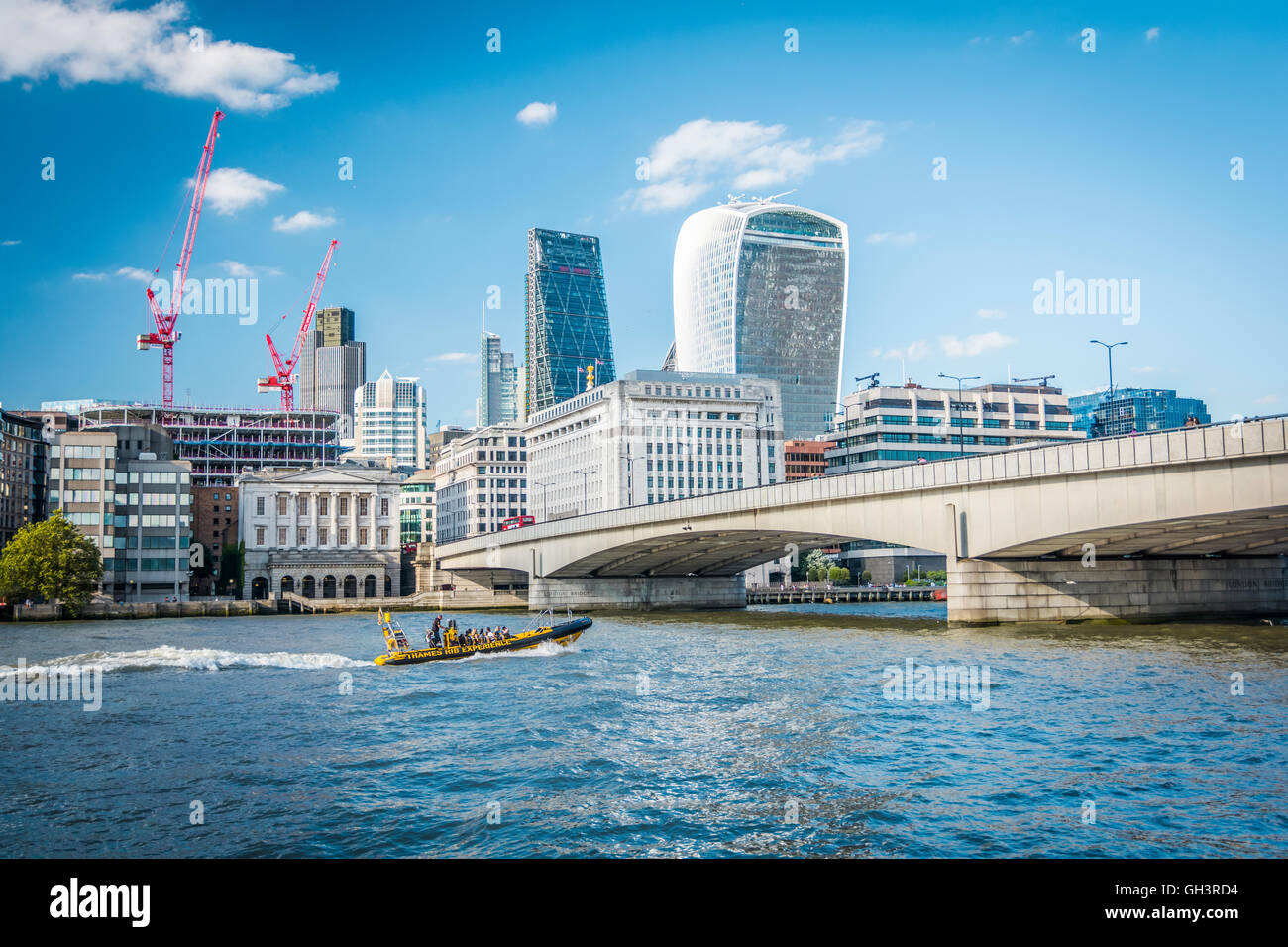 Pleasure boats passing under London Bridge on a sunny day with the ...