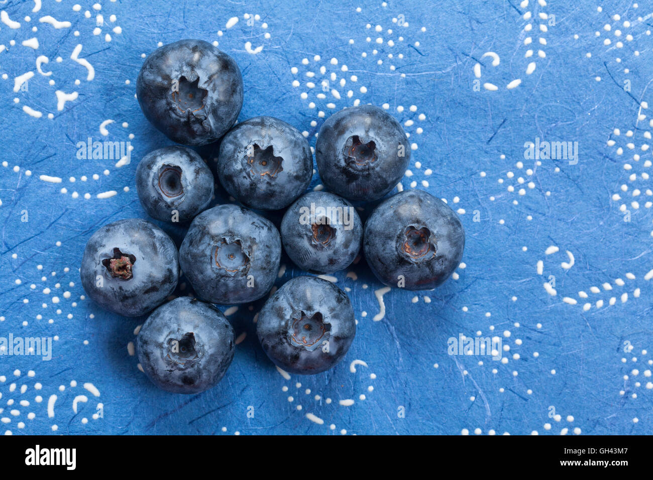 Blueberry on blue floral background Stock Photo - Alamy