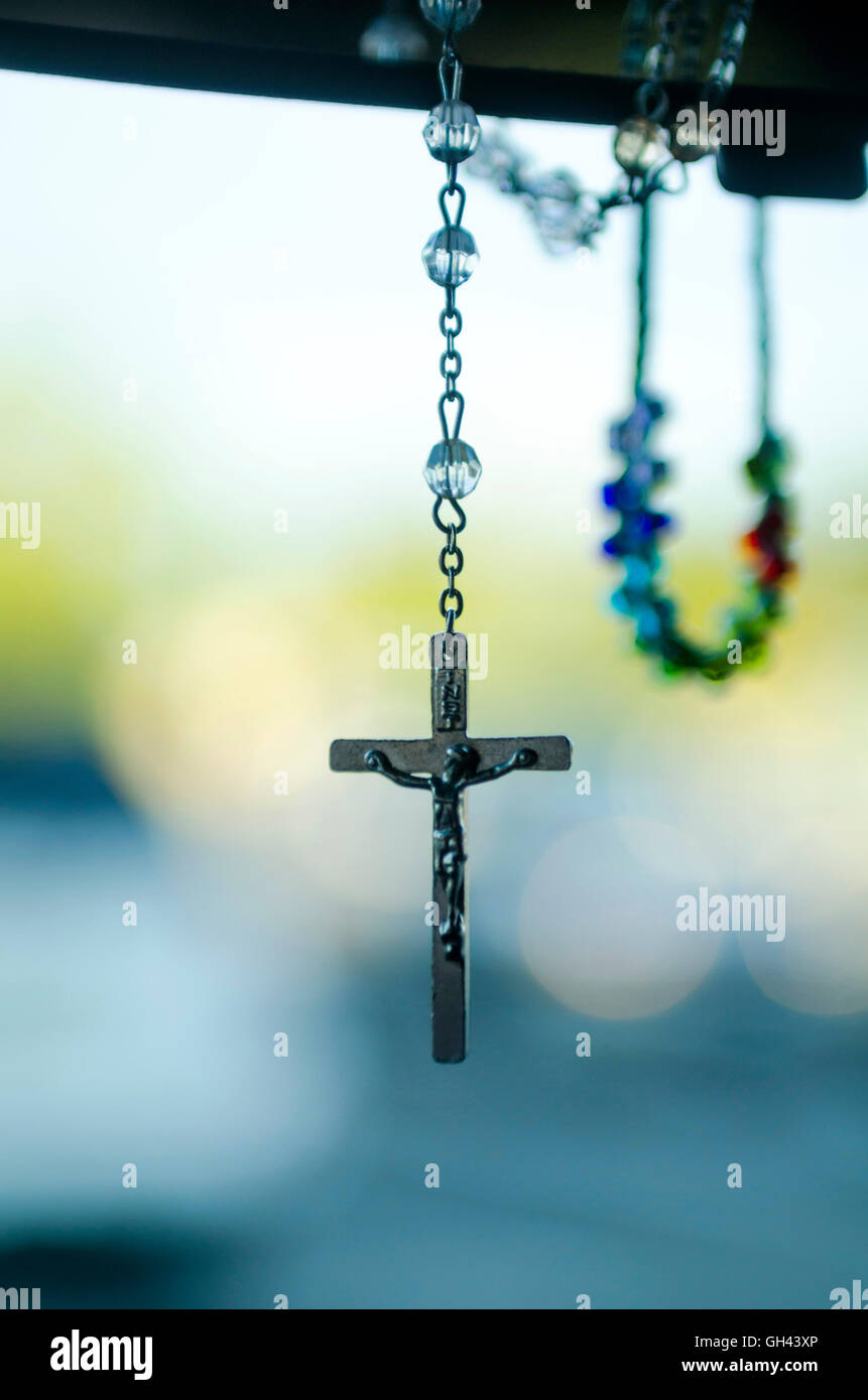 Crucifix hanging off rear view mirror Stock Photo - Alamy