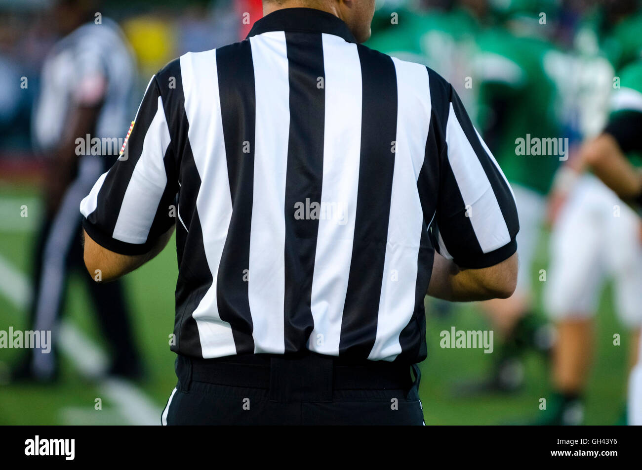 Back of referee at sporting event Stock Photo - Alamy