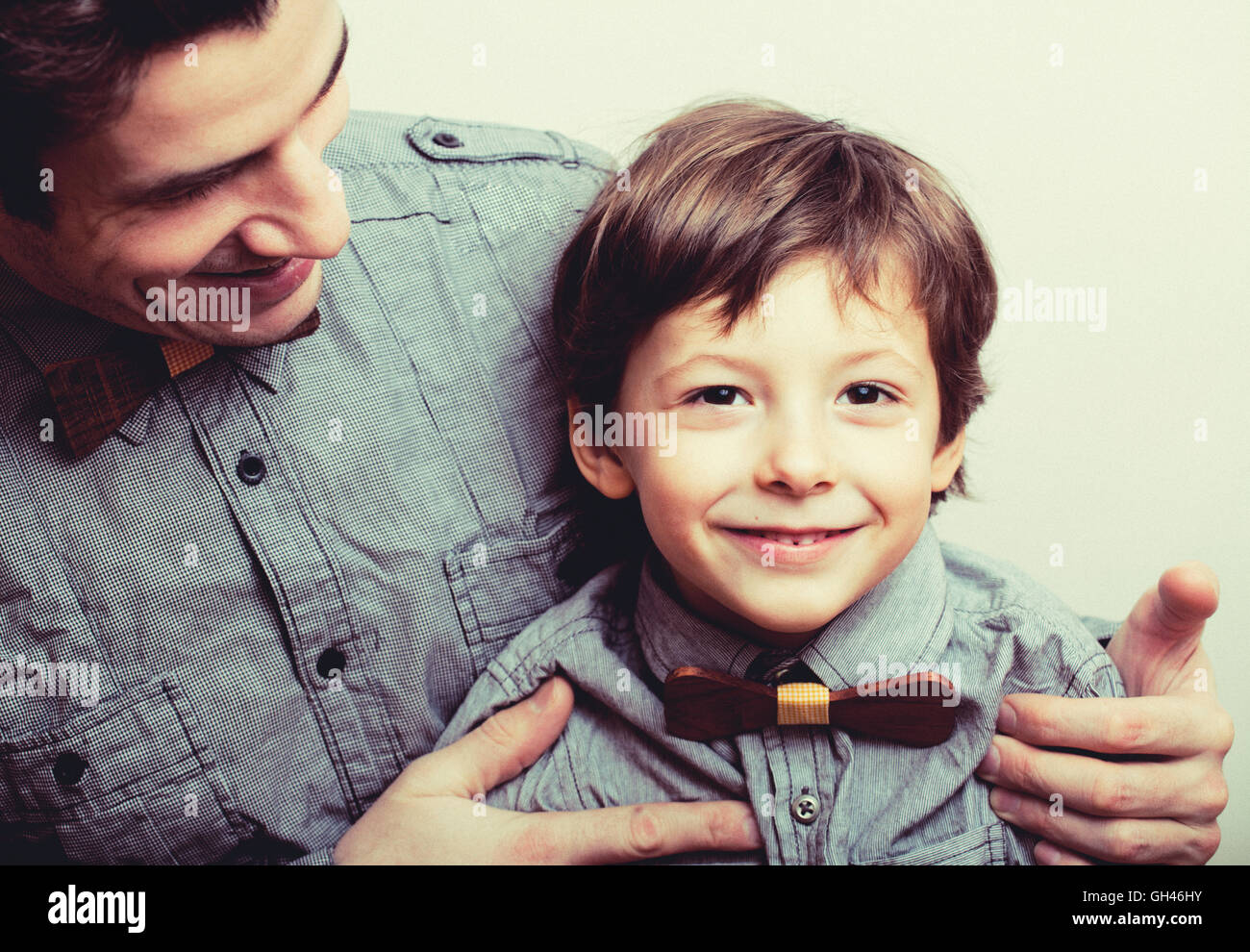 father with son in bowties on white background, casual look Stock Photo ...