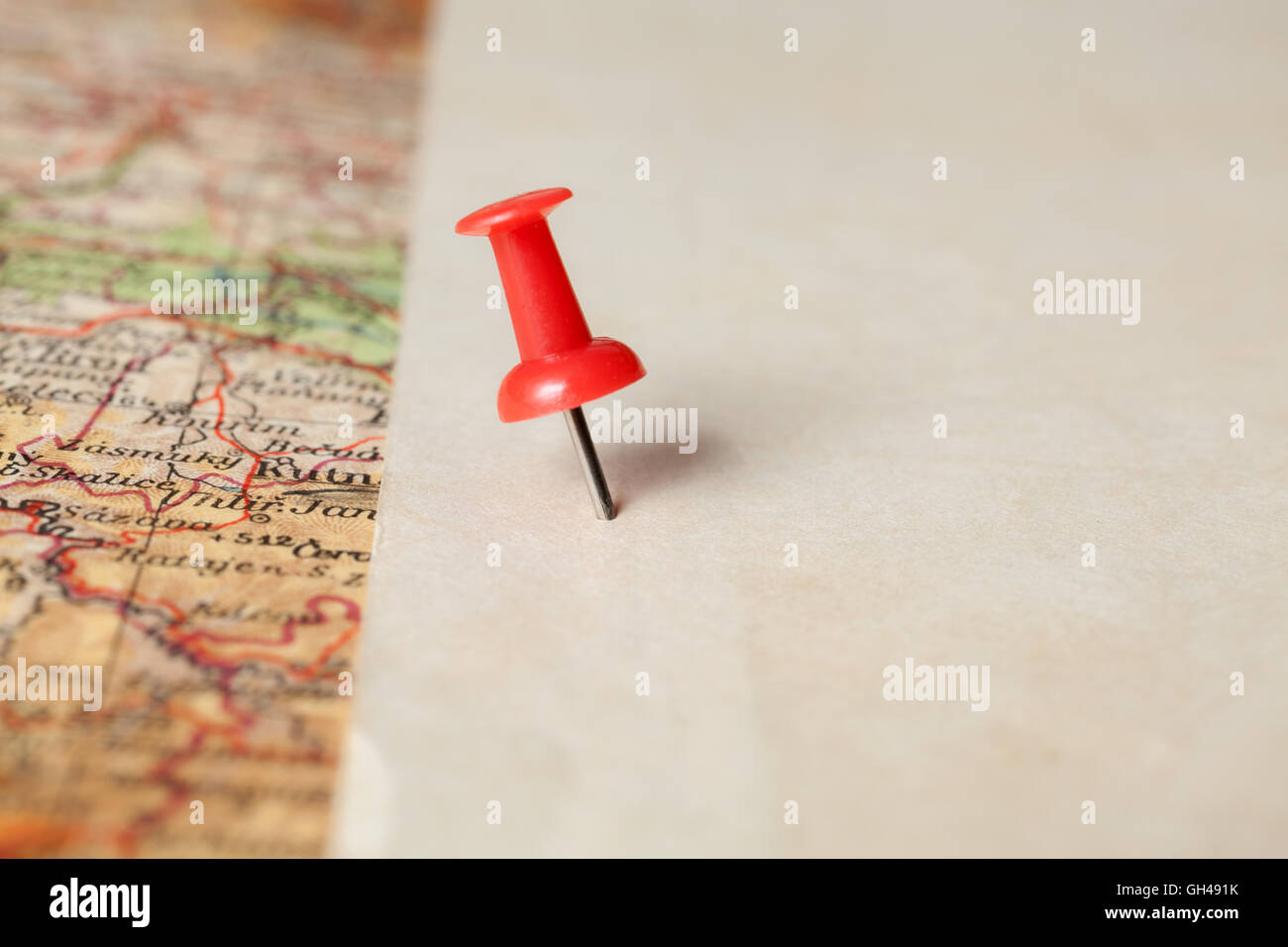 Red push pin showing the location of a destination point on a map ...