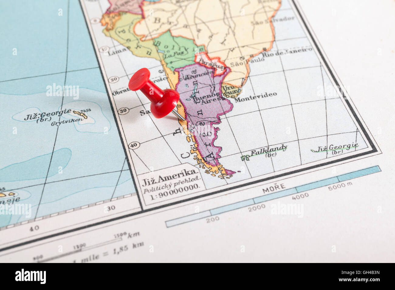 Red push pin showing the location of a destination point on a map ...