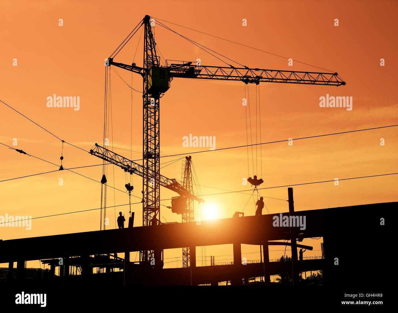 Construction cranes and construction workers on building site Stock ...