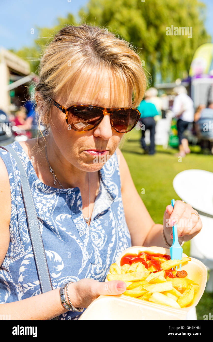 Eating chips from tray outside lady eat chips ketchup takeaway food ...