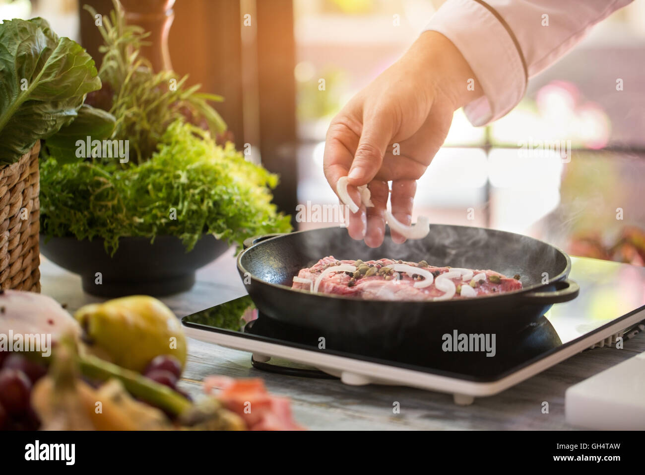 Male chef frying meat hi-res stock photography and images - Alamy
