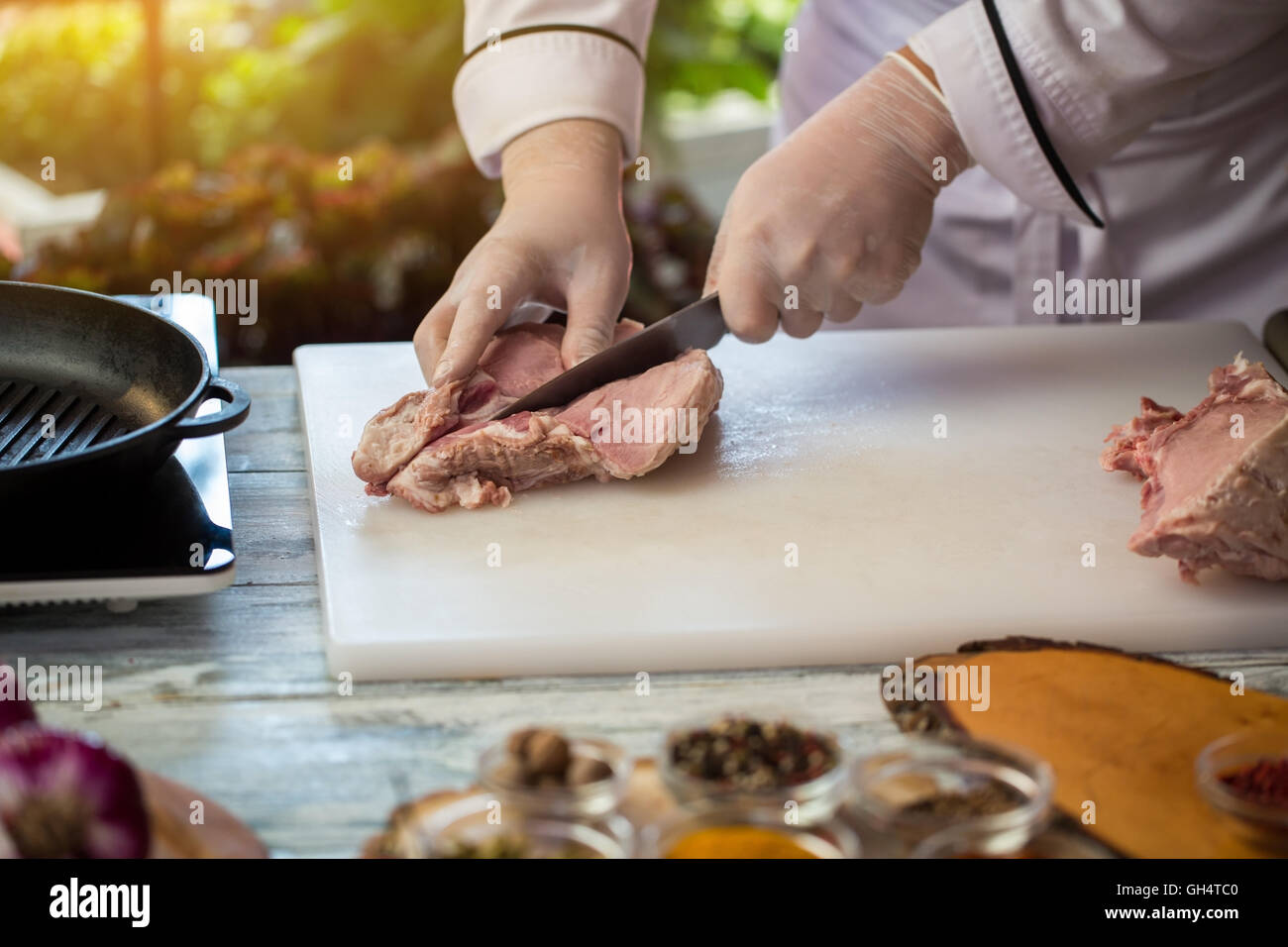 Man cuts pork meat knife hi-res stock photography and images - Alamy