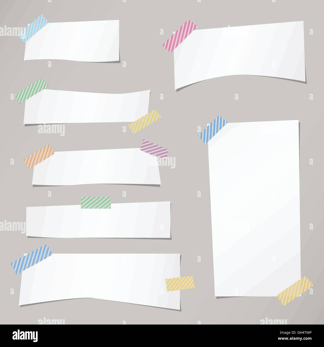 Pieces of cut white note paper are stuck with striped sticky tape on ...