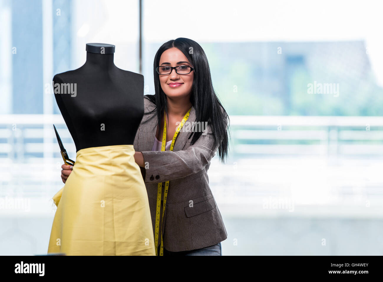 Woman tailor working on new clothing Stock Photo - Alamy