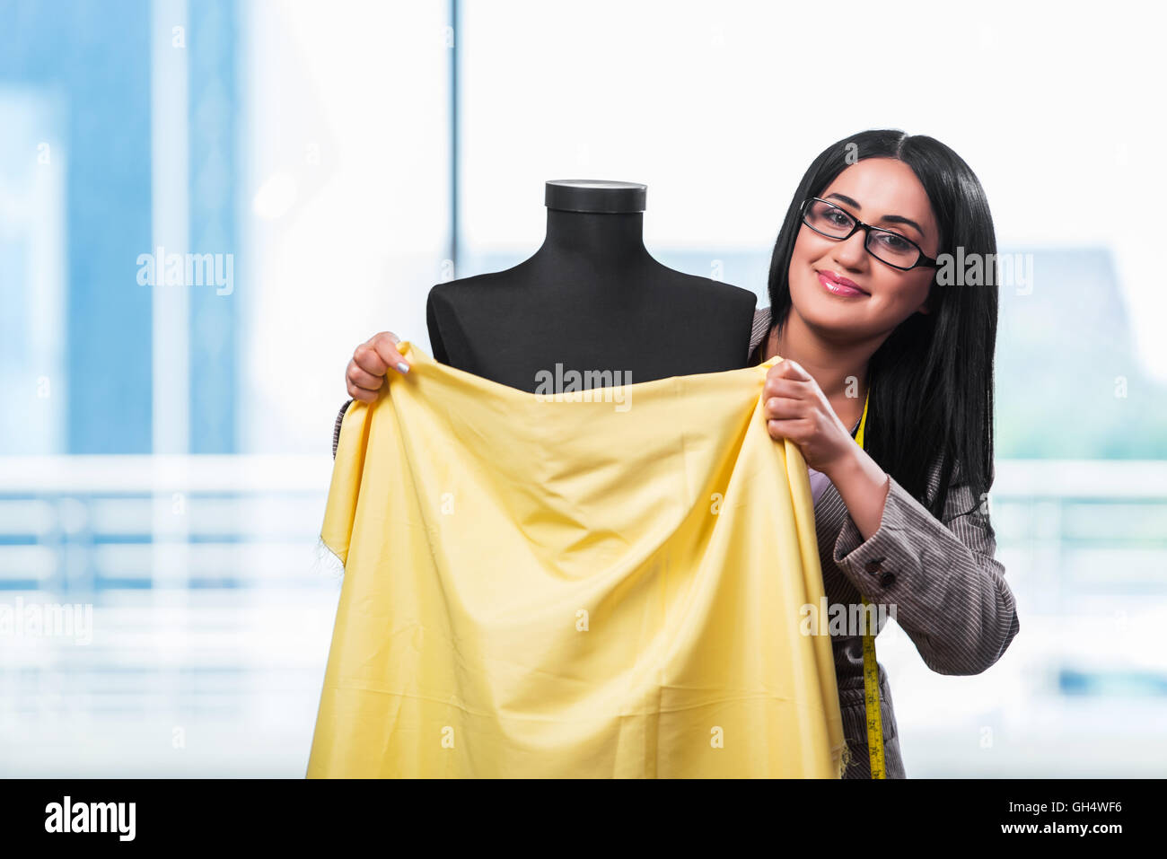 Woman tailor working on new clothing Stock Photo - Alamy