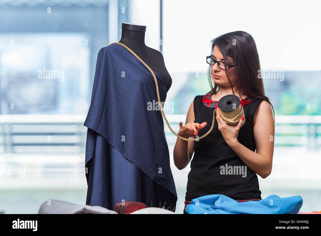 Woman tailor working on new clothing Stock Photo - Alamy