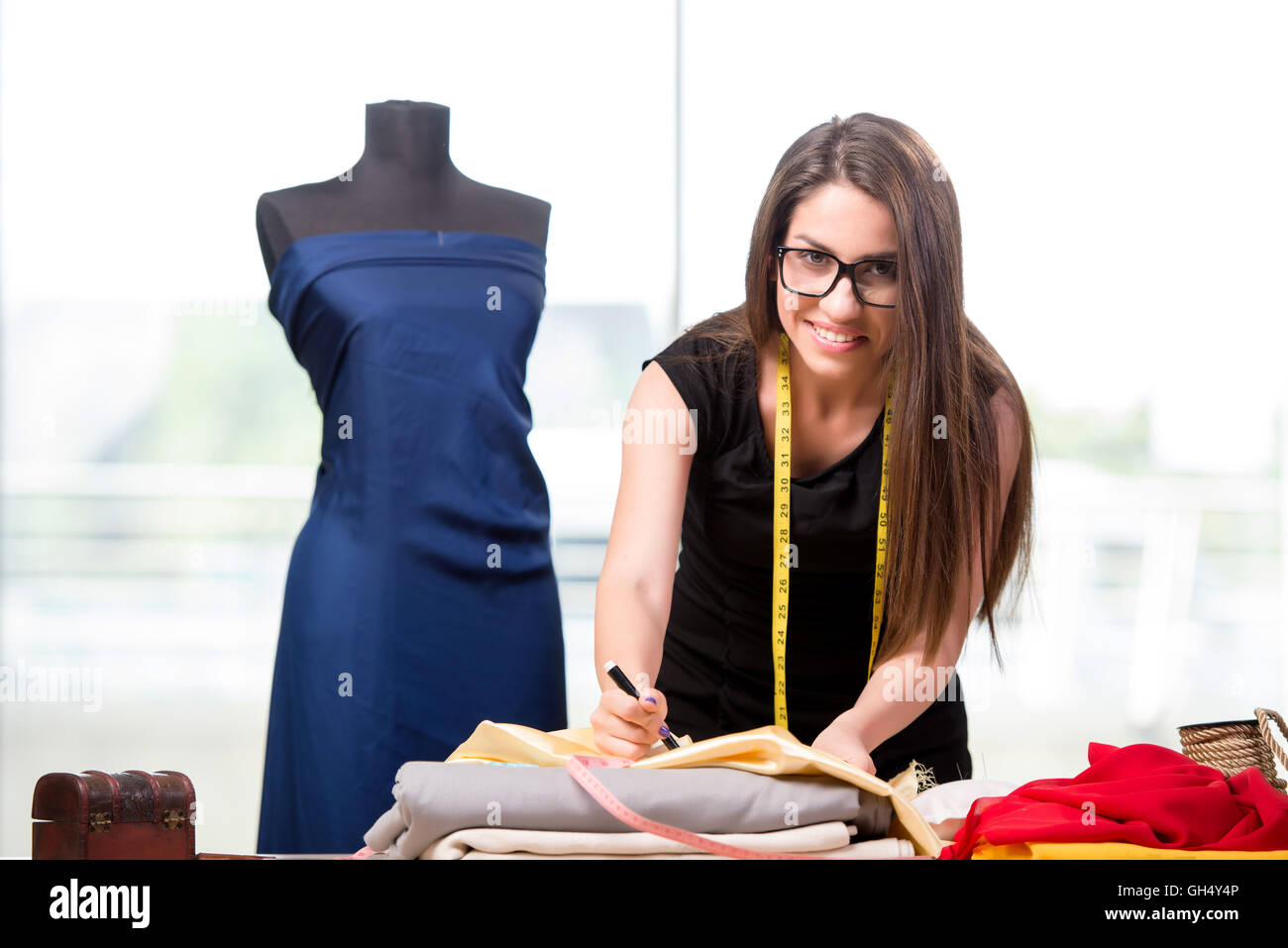 Woman tailor working on new clothing Stock Photo - Alamy
