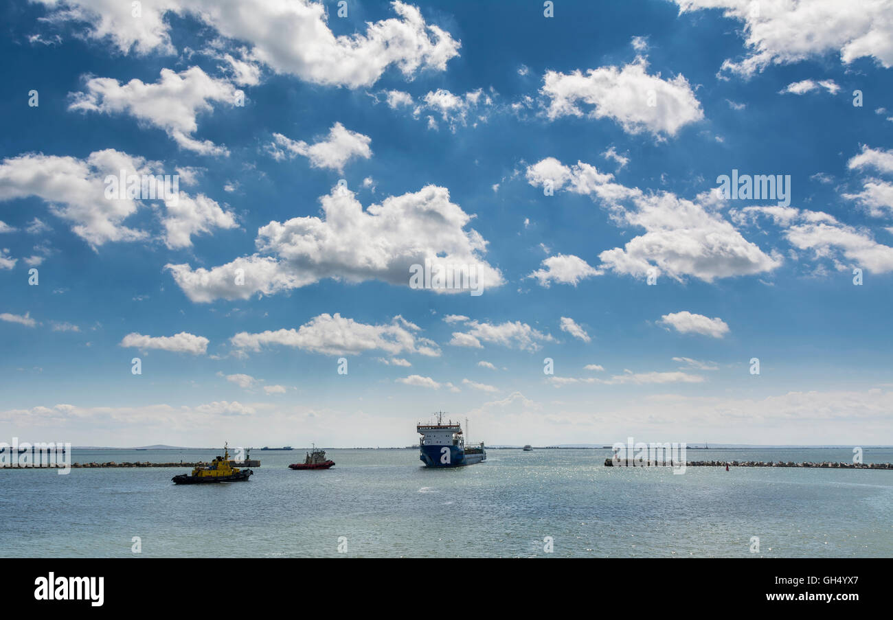 Cargo Ship and Tugboat. Seascape with beautiful sky Stock Photo - Alamy