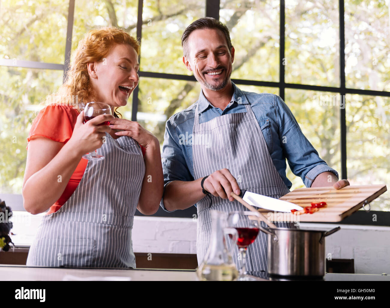 Man adding cut vegetables into pot Stock Photo - Alamy