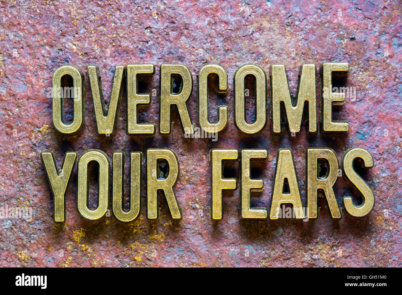 overcome your fears phrase made from metallic letters over rusty ...