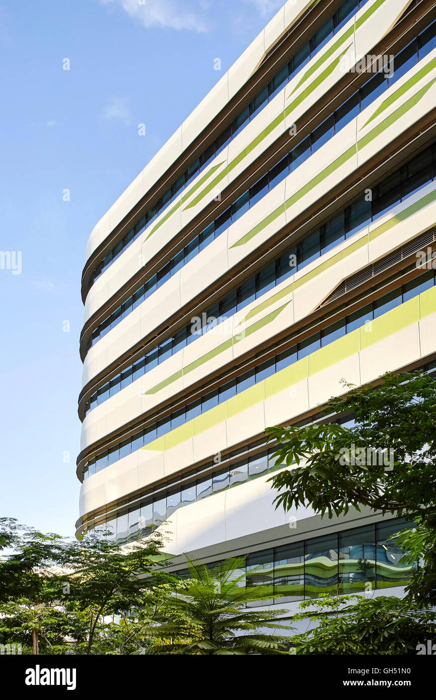 White concrete facade with glazing and green cladding. Singapore ...