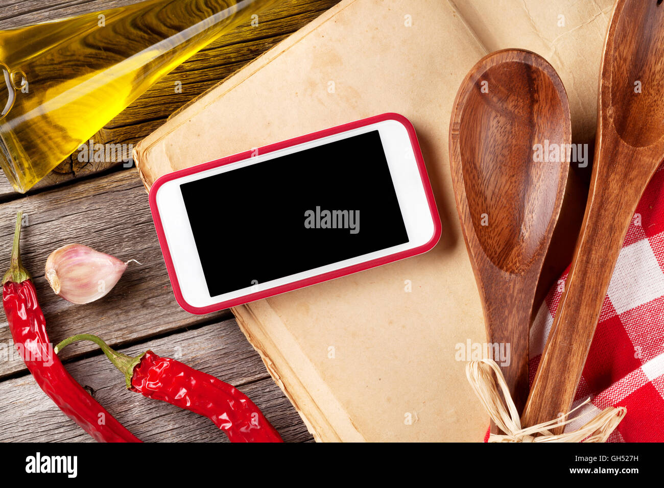 Kitchen table with ingredients, utensils and smartphone with blank ...