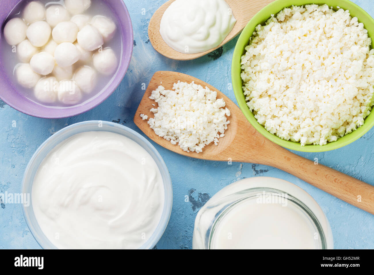 Dairy products on stone table. Sour cream, milk, cheese, yogurt and ...