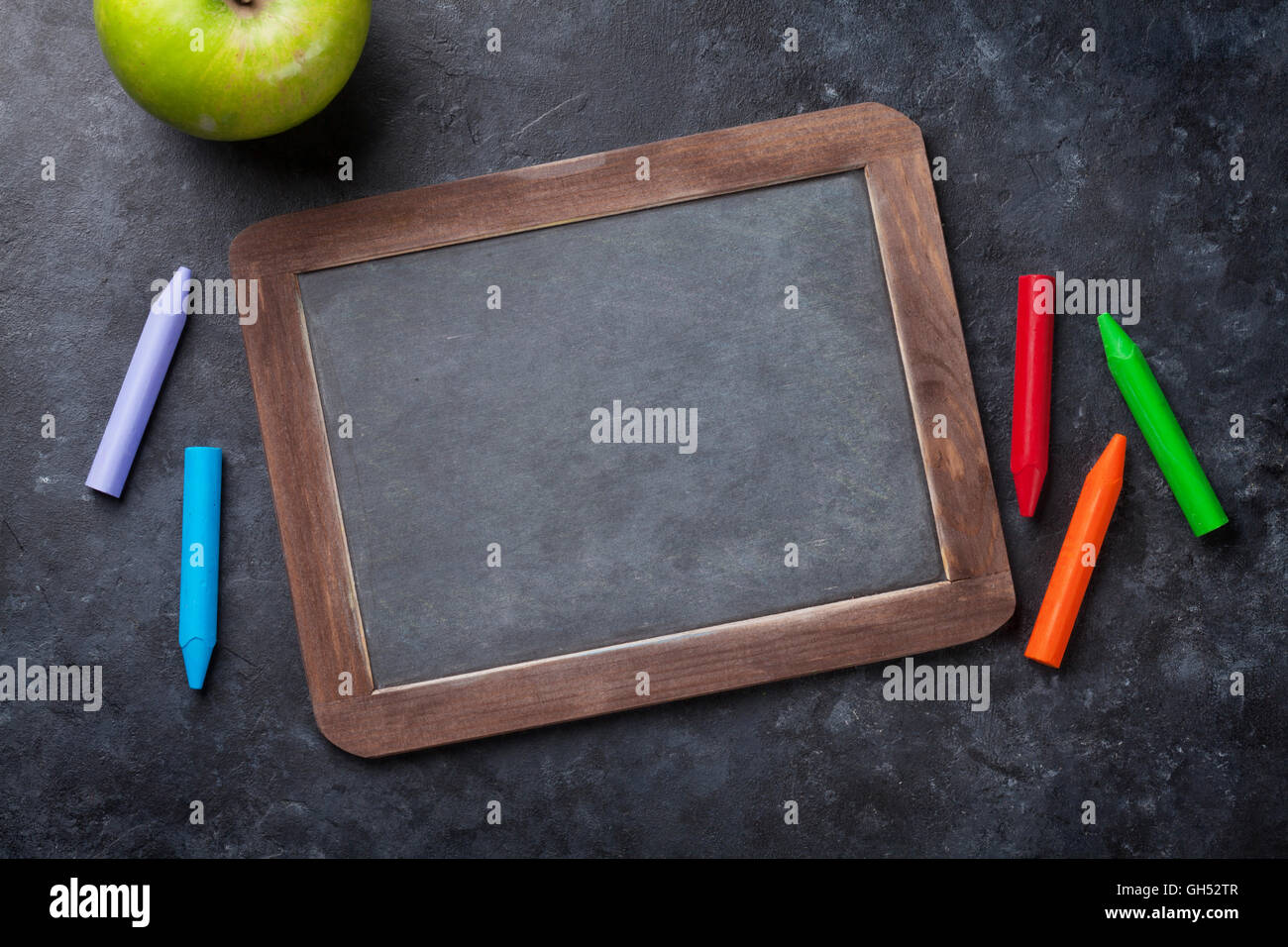 Chalkboard for your text and colorful chalks. Back to school concept ...