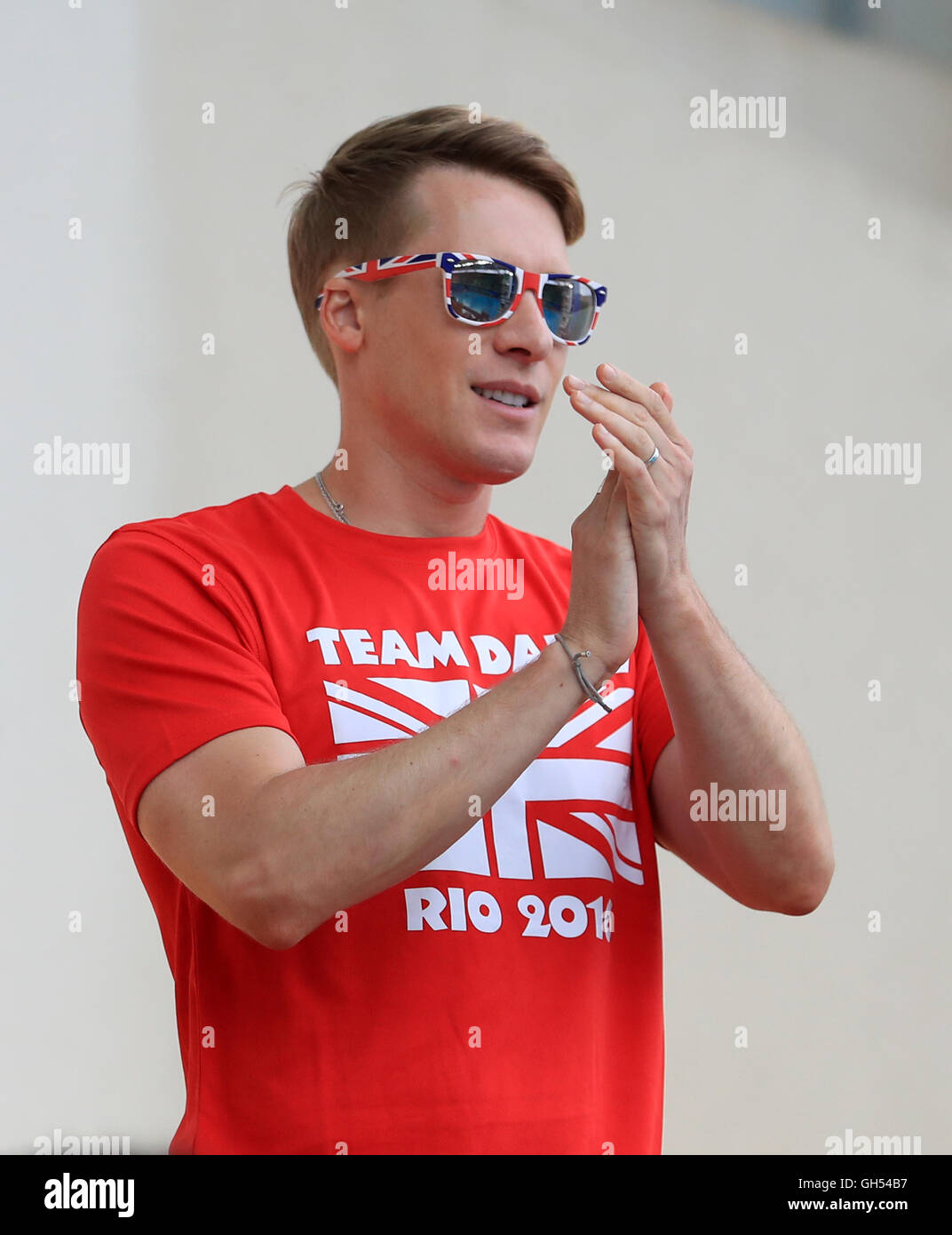 Tom Daley's partner Dustin Lance Black shows his support in the stands ...
