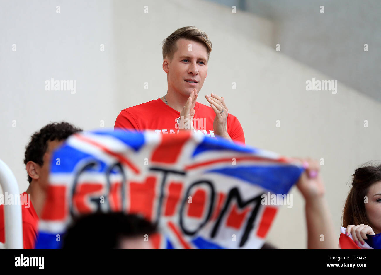 Tom Daley's partner Dustin Lance Black shows his support in the stands ...