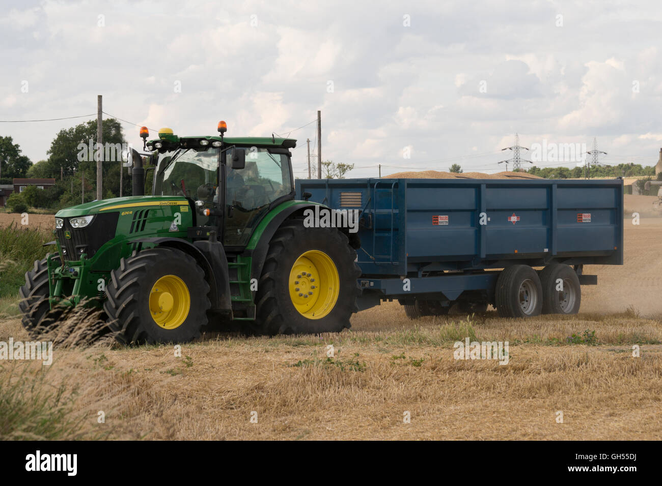 Off, loading, the, Harvester, wheat, load, onto the, awaiting, tractor ...