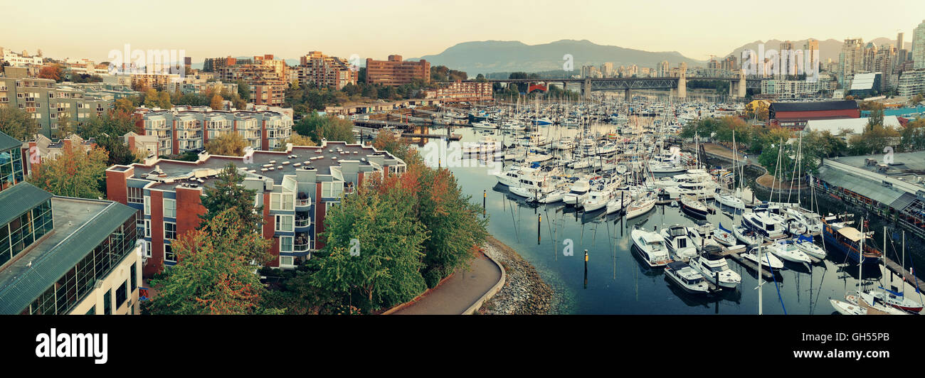 Vancouver harbor view with urban apartment buildings and bay boat in ...