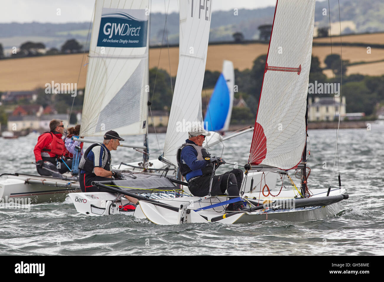 Competitive sailing dinghy racing, in the estuary of the River Exe ...