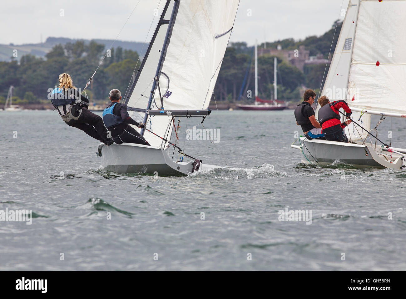 Competitive sailing dinghy racing, in the estuary of the River Exe ...