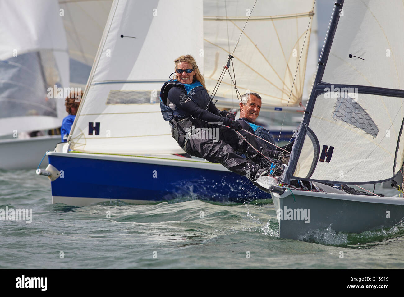 Competitive sailing dinghy racing, in the estuary of the River Exe ...
