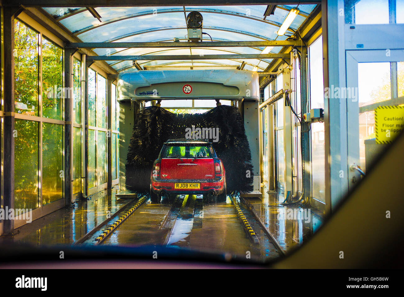 Inside an operational automated car wash seen from inside a waiting car ...