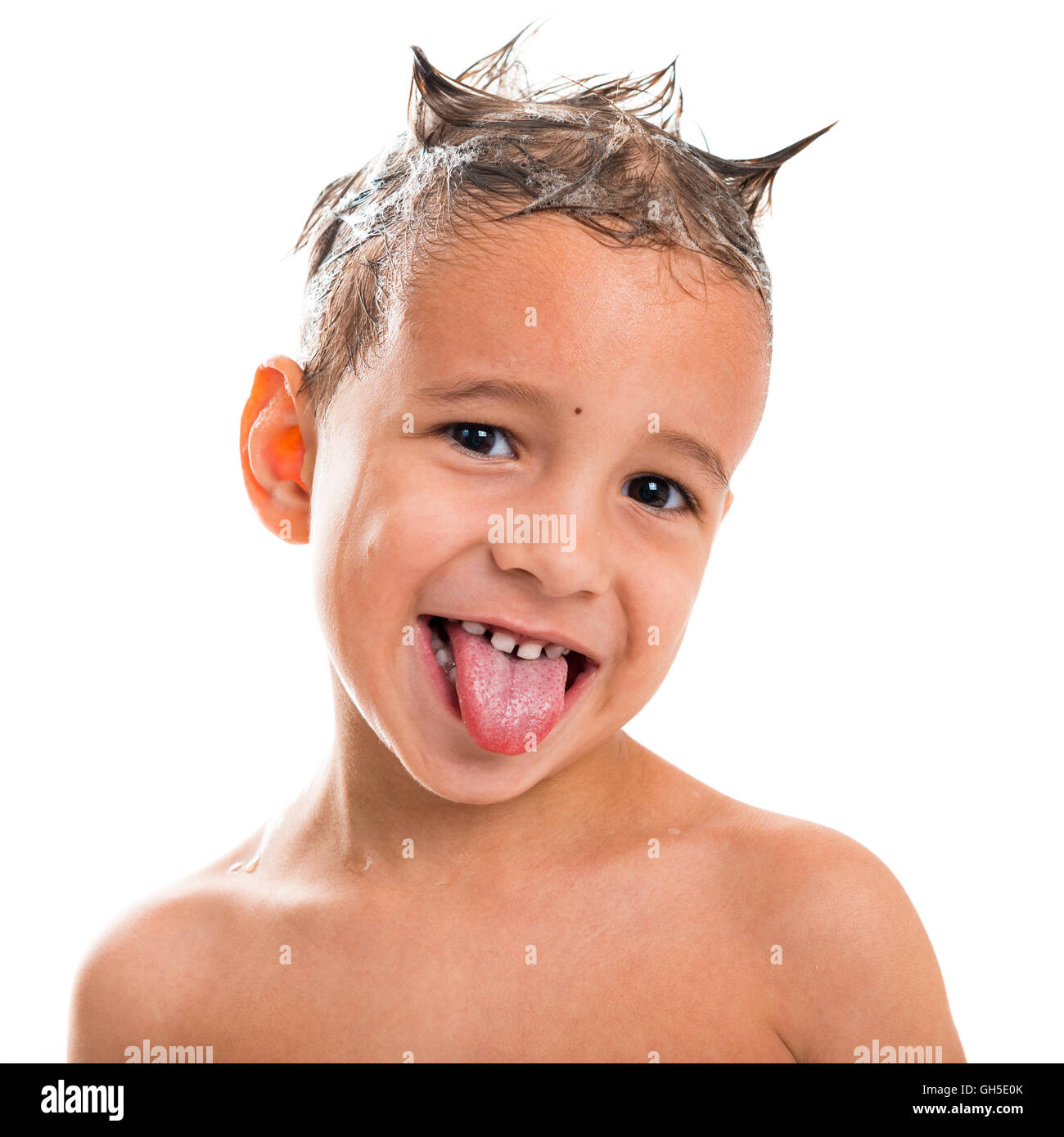 Portrait of a happy child with a lathered head on a white background ...