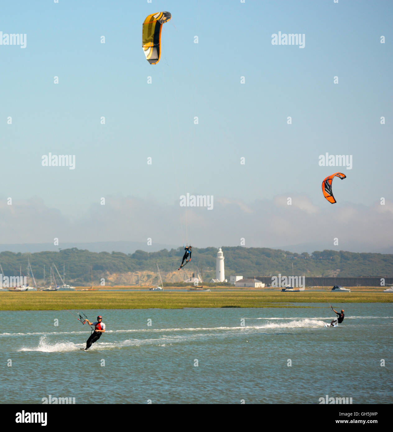 Kiteboarders make the most of a windy day in the lagoon behind the ...