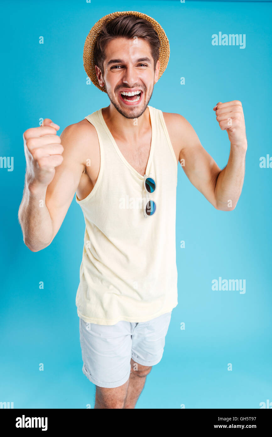 Happy man celebrating success screaming hi-res stock photography and ...